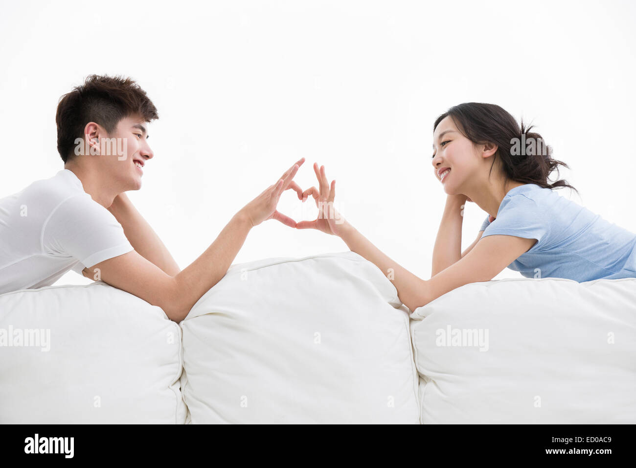 Young couple making heart shape with their hands Stock Photo - Alamy