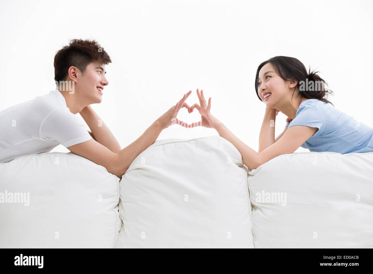 Young couple making heart shape with their hands Stock Photo - Alamy