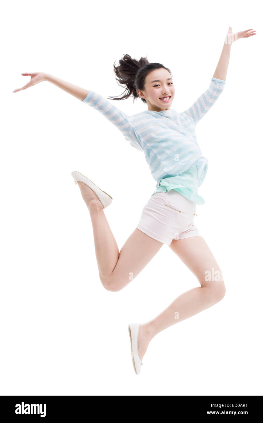 Happy young woman jumping Stock Photo - Alamy