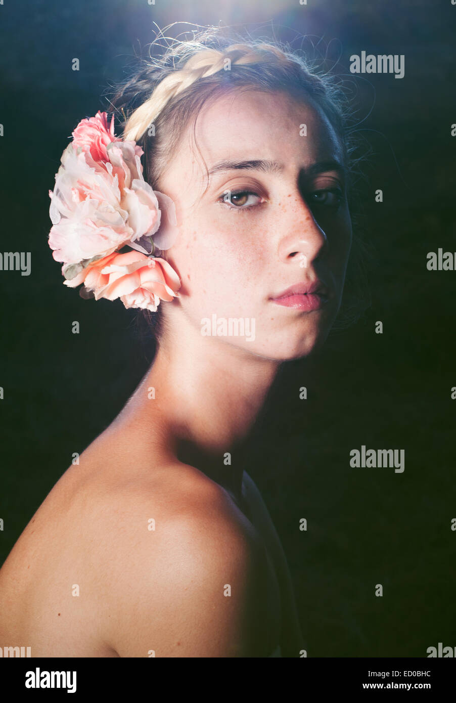 Portrait of woman with flower in hair Stock Photo - Alamy