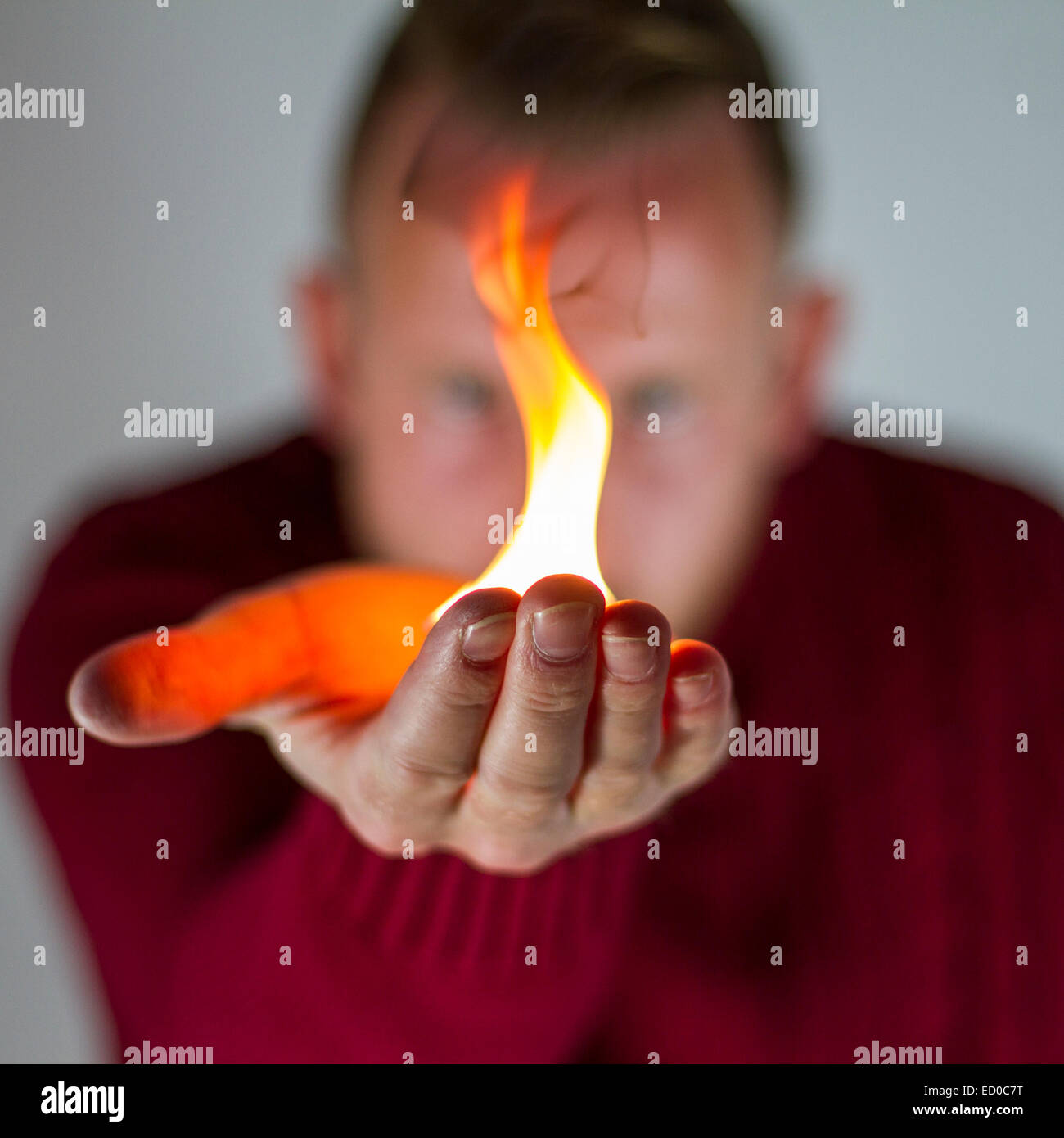 Man holding fire Stock Photo - Alamy