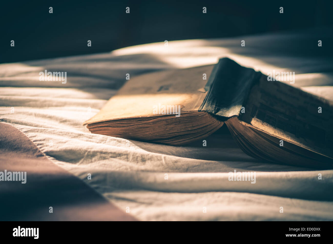 Open book on bed Stock Photo - Alamy