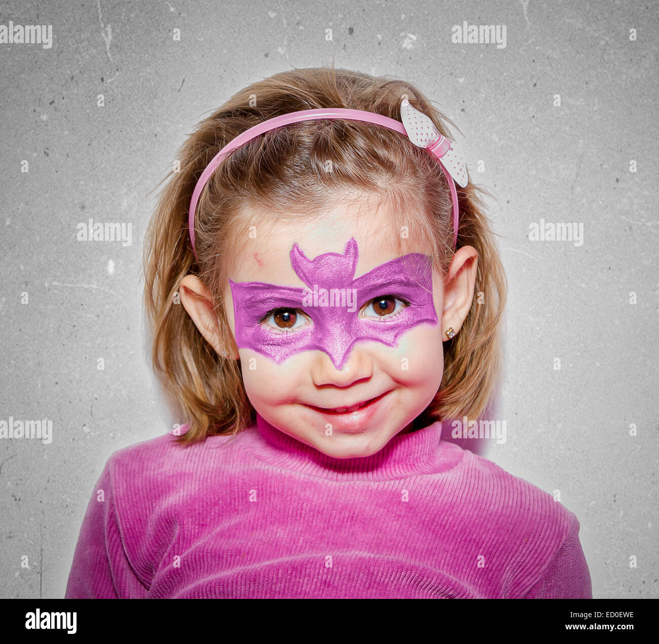 Portrait of a smiling girl with a bat mask drawn on her face Stock ...