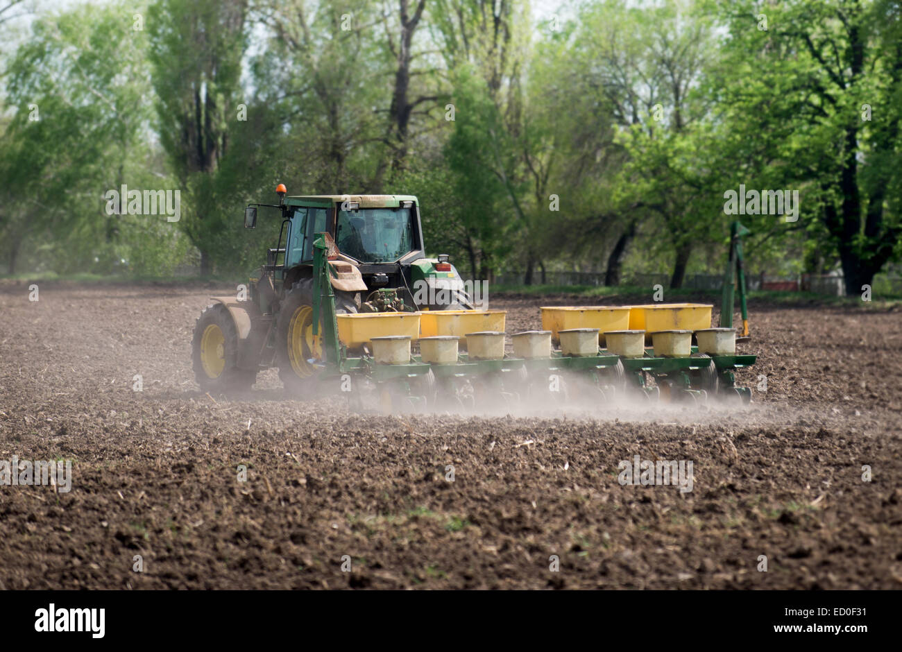 The tractor processes the ground Stock Photo - Alamy