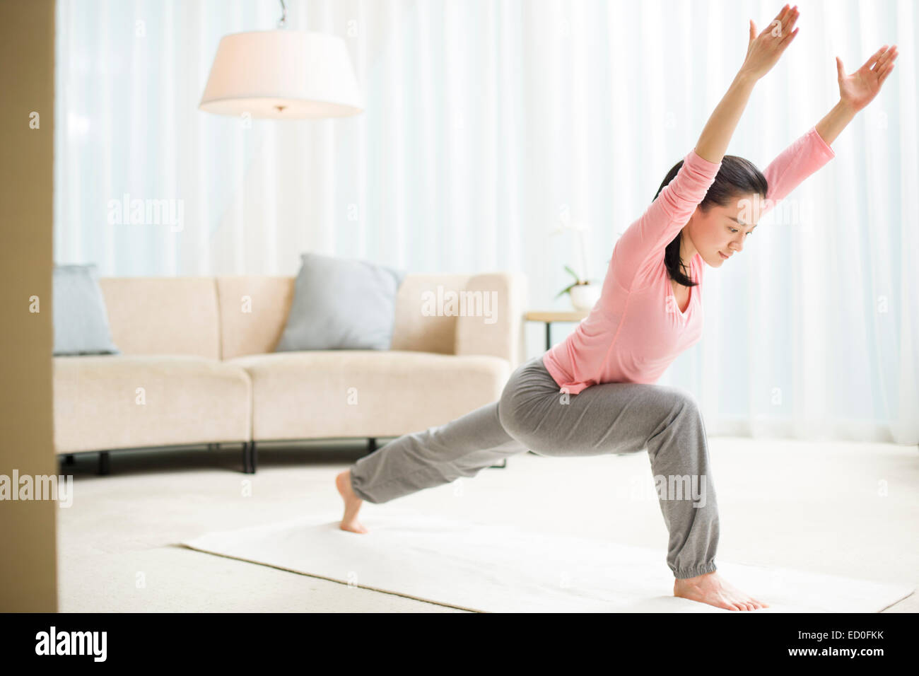 Young woman crouching yoga hi-res stock photography and images - Alamy