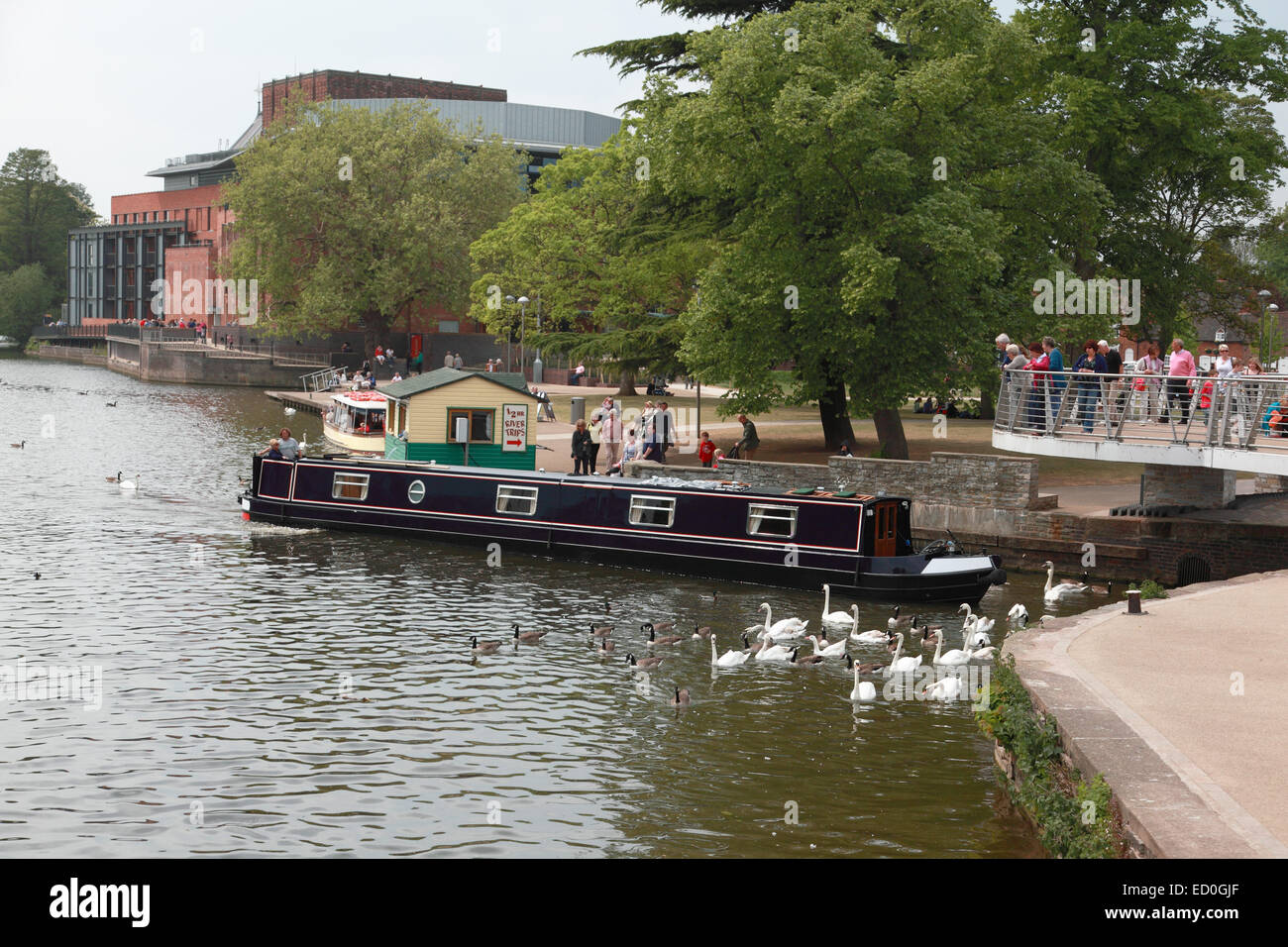 A narrowboat leaving the river Avon and entering the canal lock leading ...
