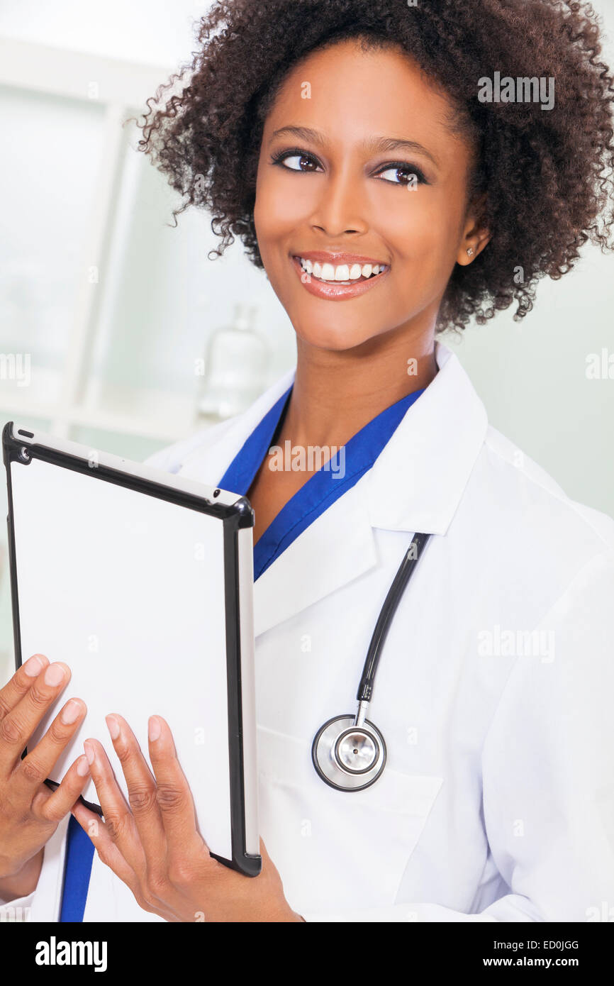 A black African American female medical doctor using a tablet computer ...
