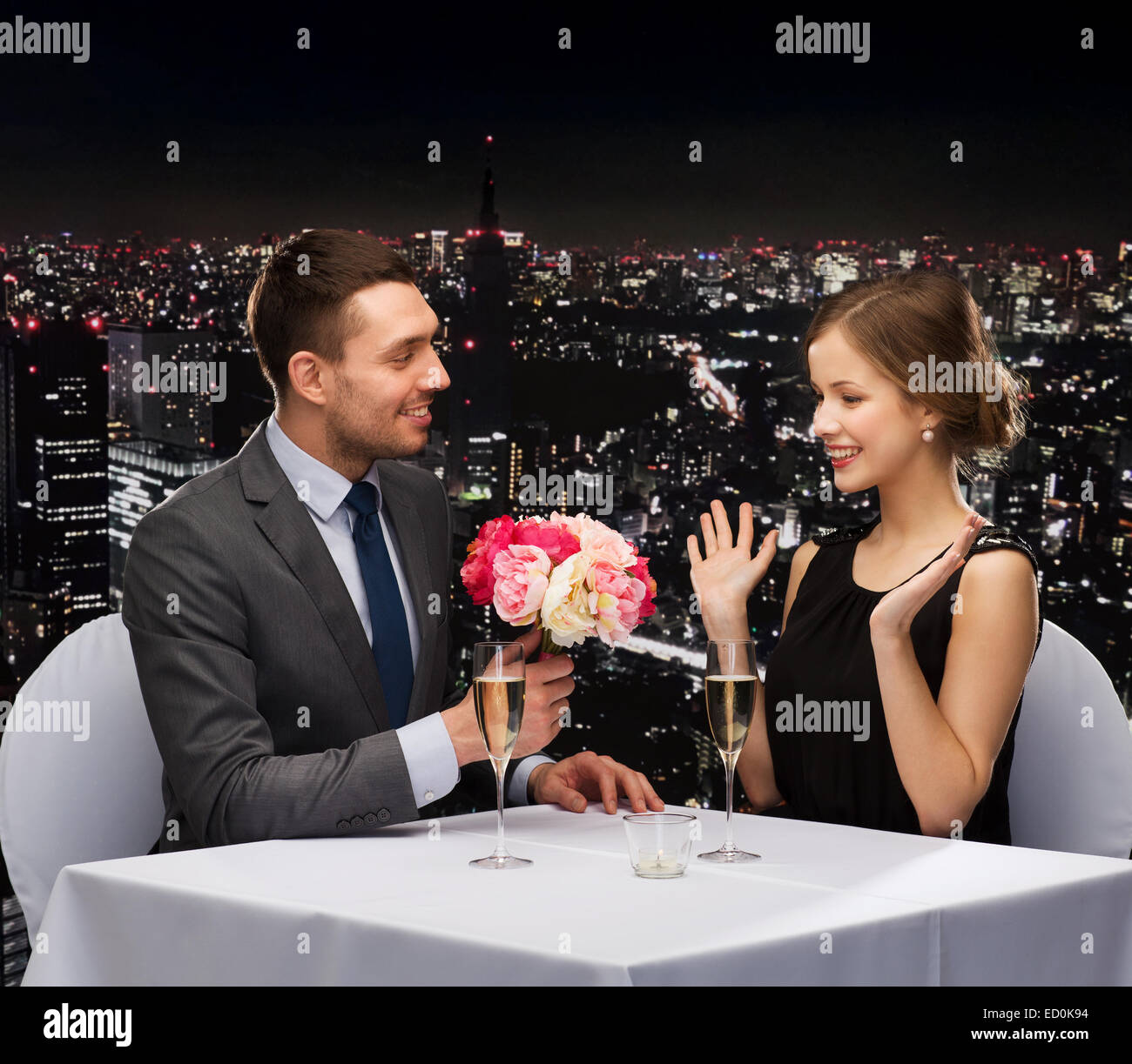 smiling man giving flower bouquet to woman Stock Photo - Alamy