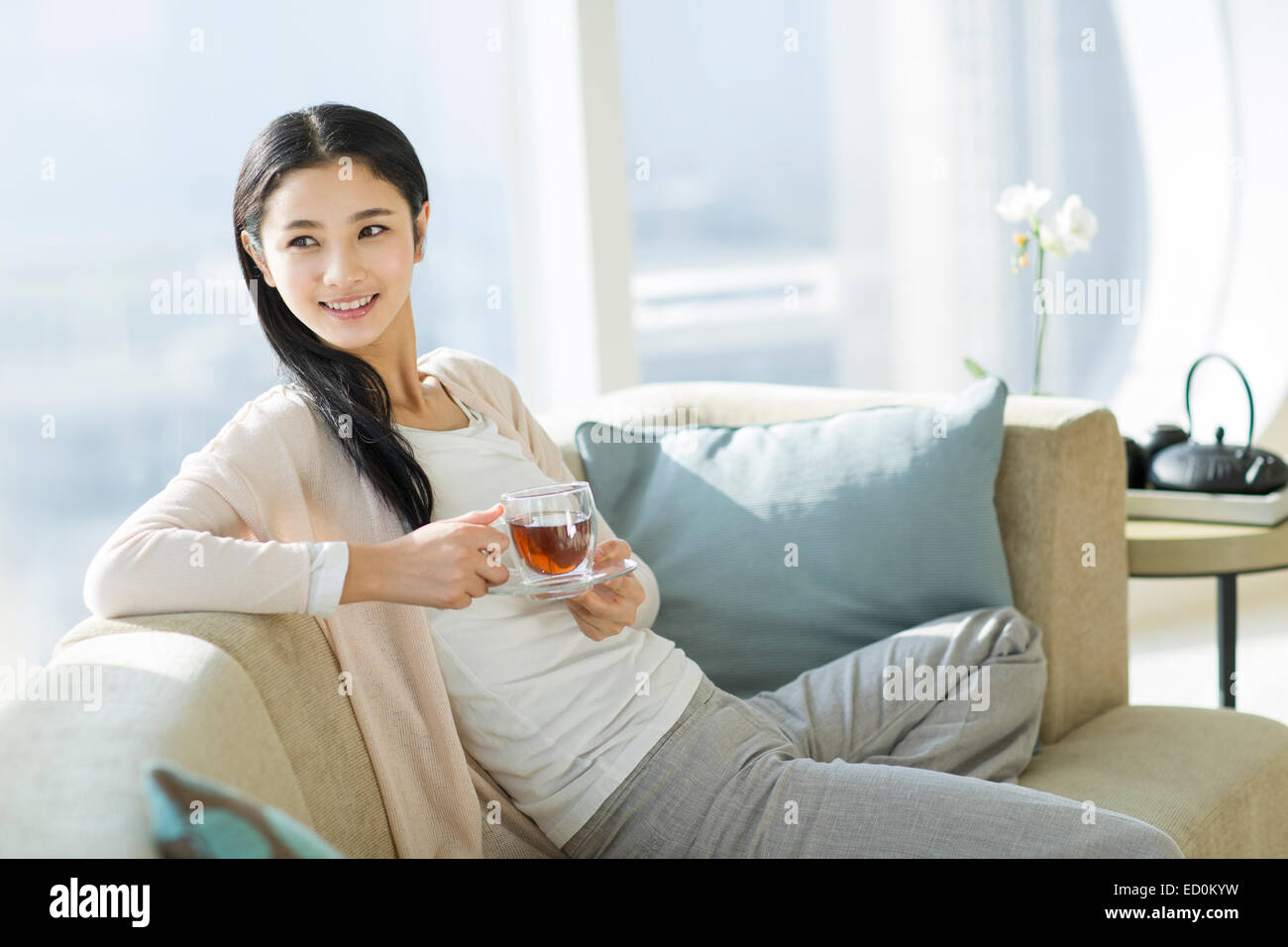 Happy young woman drinking black tea Stock Photo - Alamy