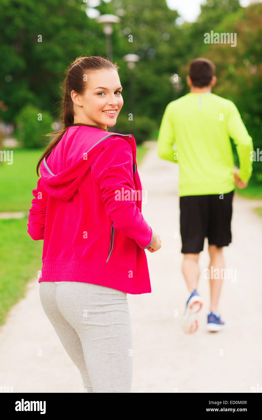 smiling couple running outdoors Stock Photo - Alamy