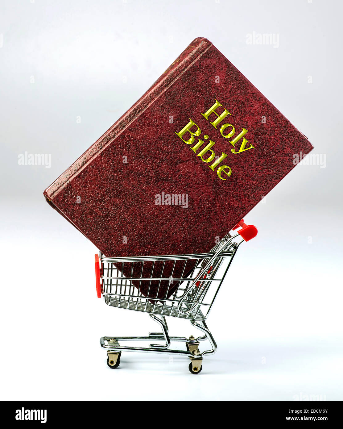 Shopping for religion with bible in shopping cart Stock Photo - Alamy