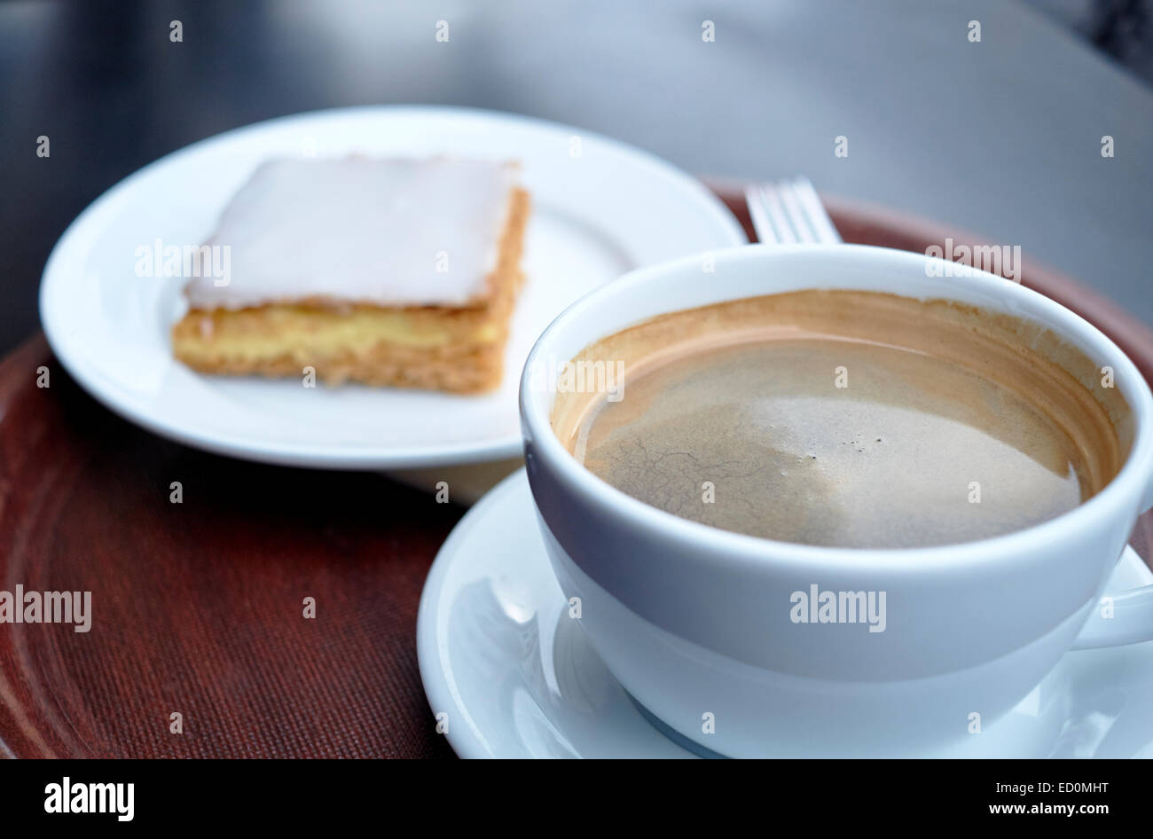 Shallow depth of field shot of coffee cup with mille feuille in the ...