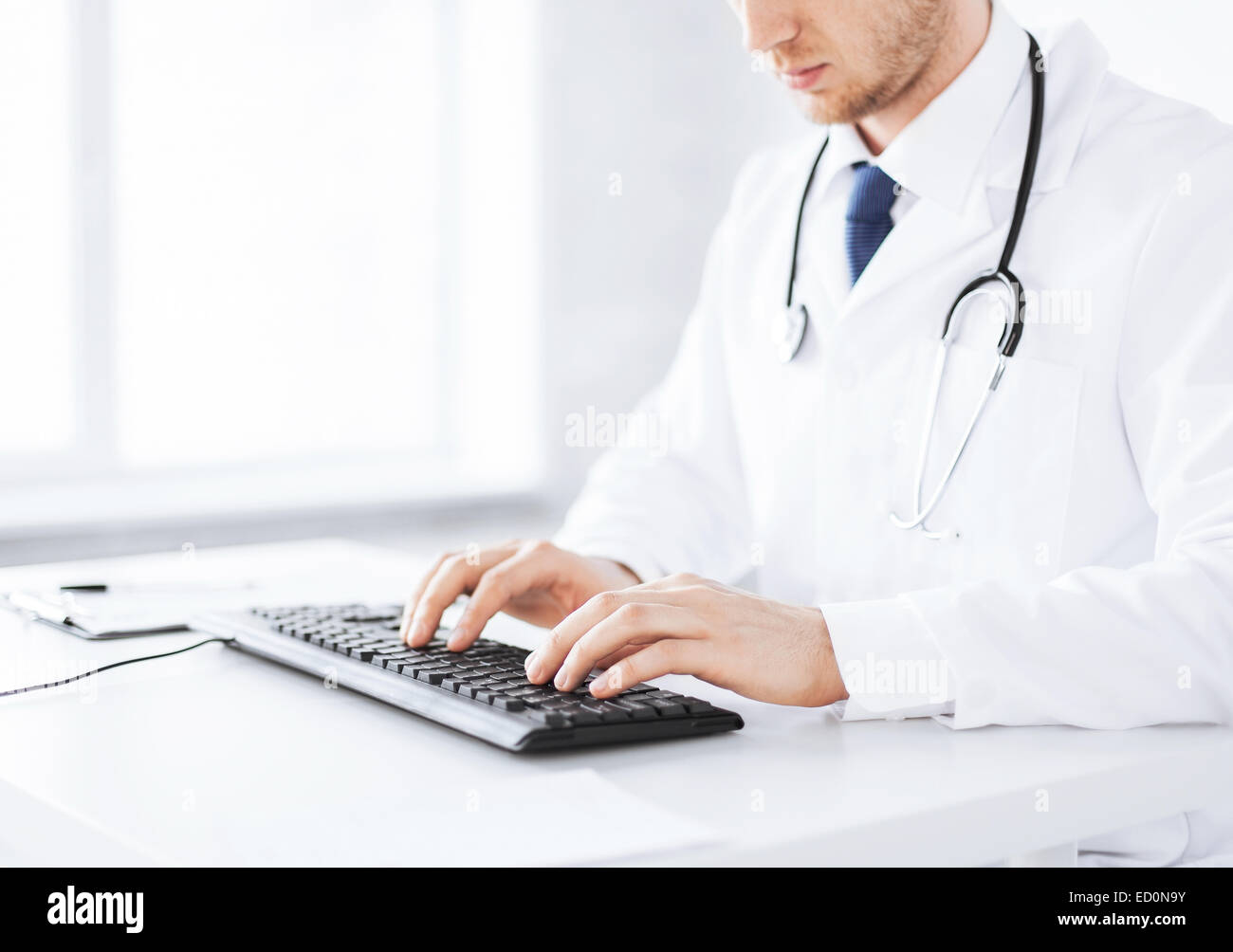 male doctor typing on the keyboard Stock Photo - Alamy