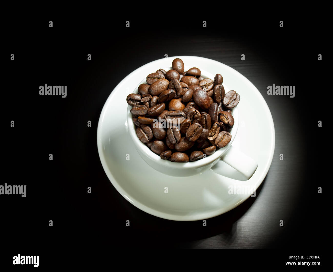 Single white coffee cup full of whole roasted coffee beans Stock Photo ...