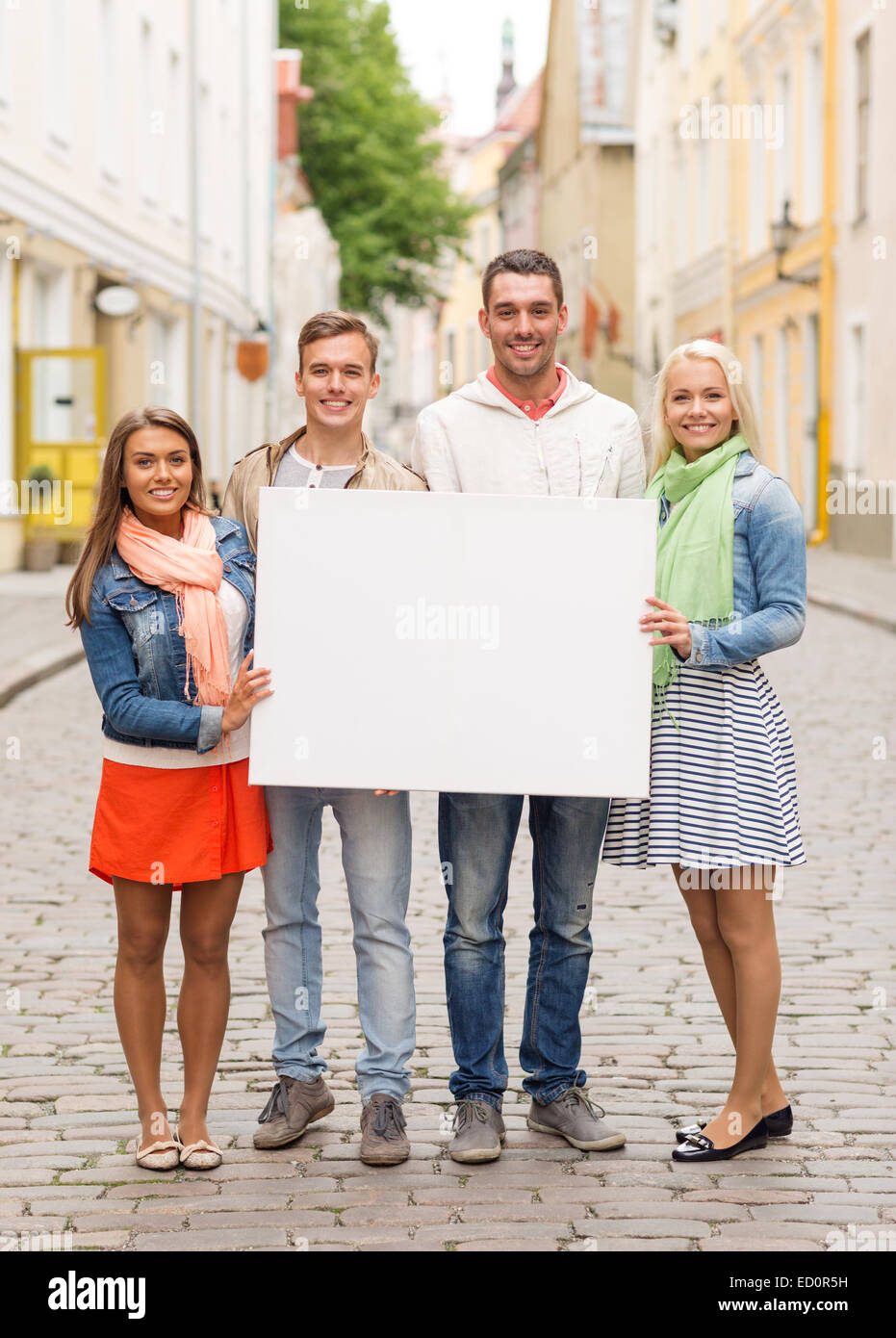 group of smiling friends with blank white board Stock Photo - Alamy