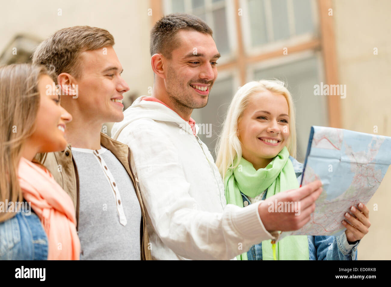 group of friends with map exploring city Stock Photo - Alamy