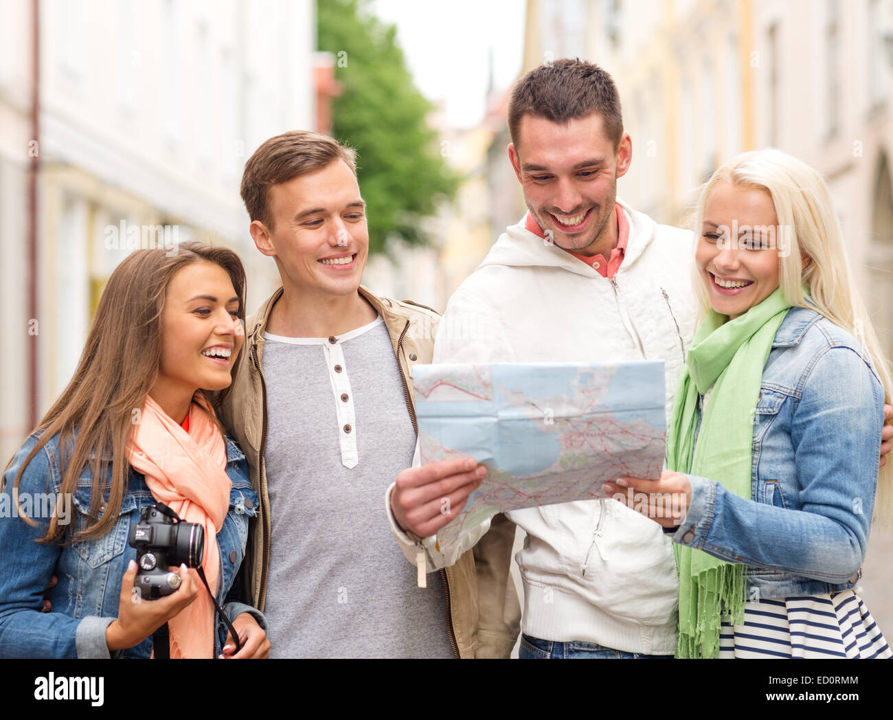 group of smiling friends with map and photocamera Stock Photo - Alamy