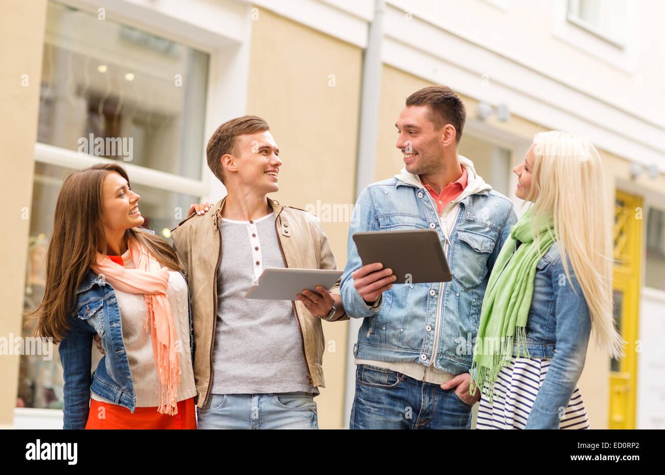group of smiling friends with tablet pc computers Stock Photo - Alamy