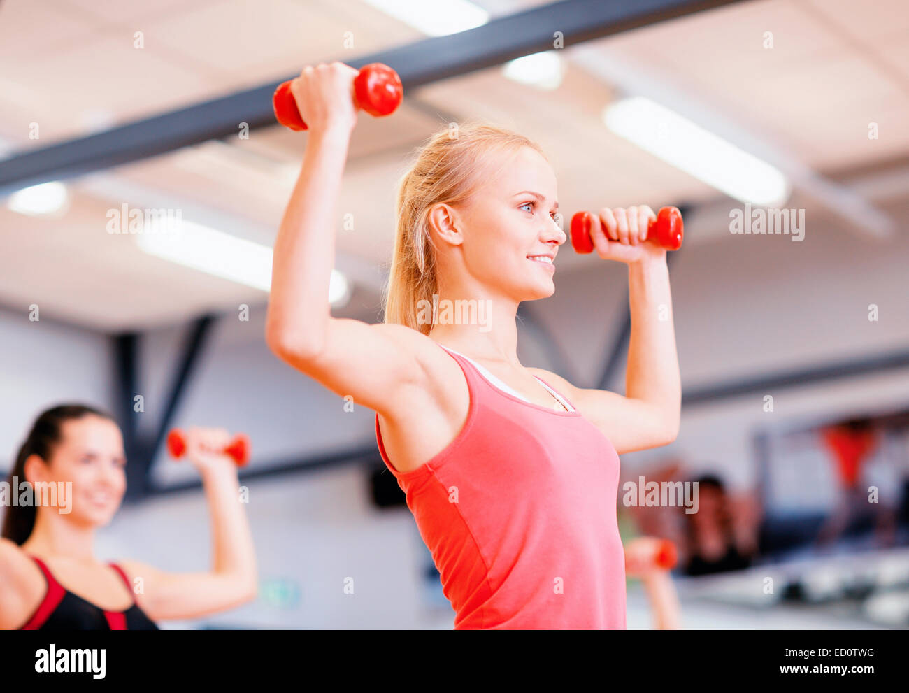 group of smiling people working out with dumbbells Stock Photo - Alamy