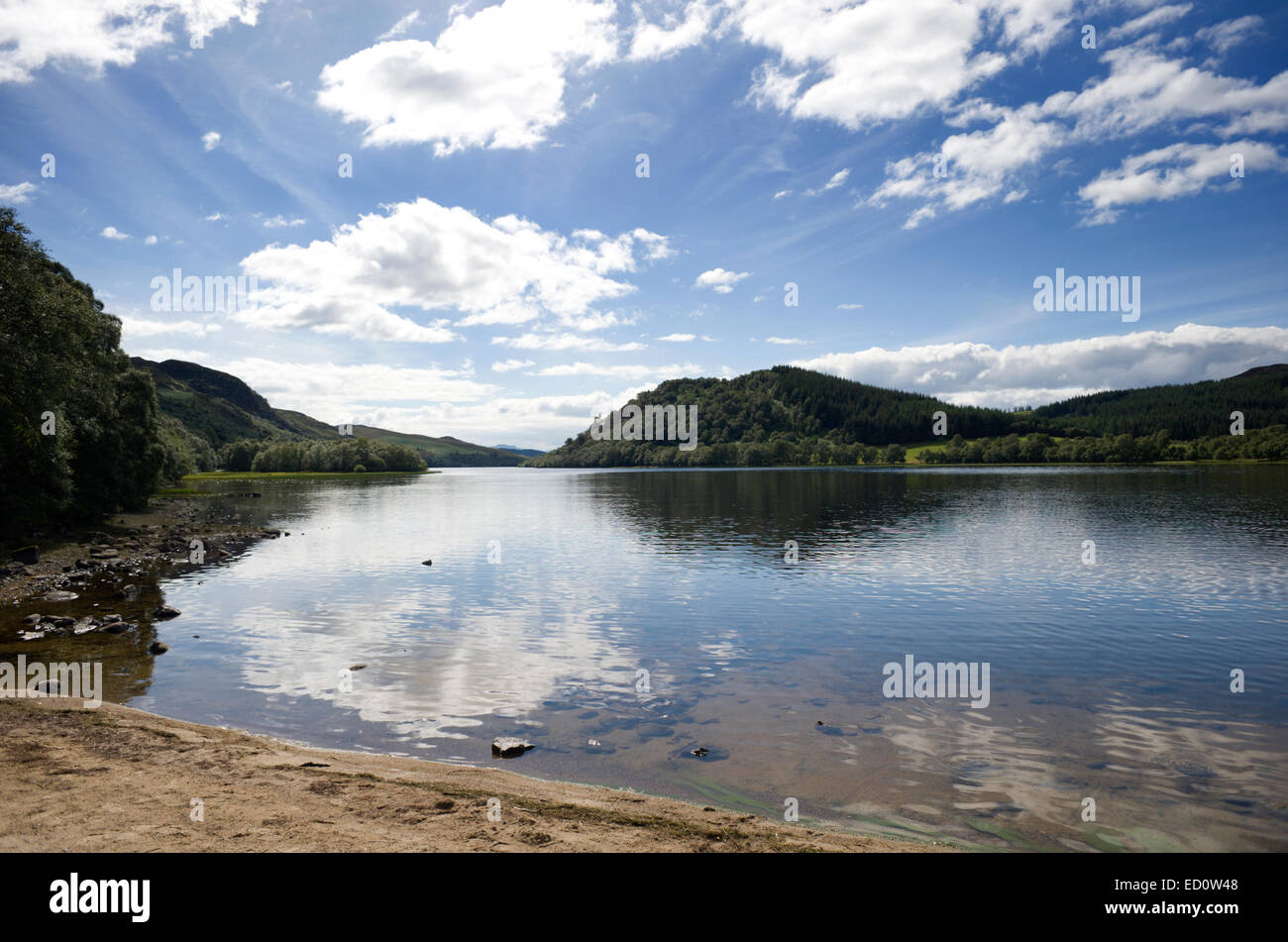 Summer sky reflected in the calm waters of the RSPBs Loch Ruthven in ...
