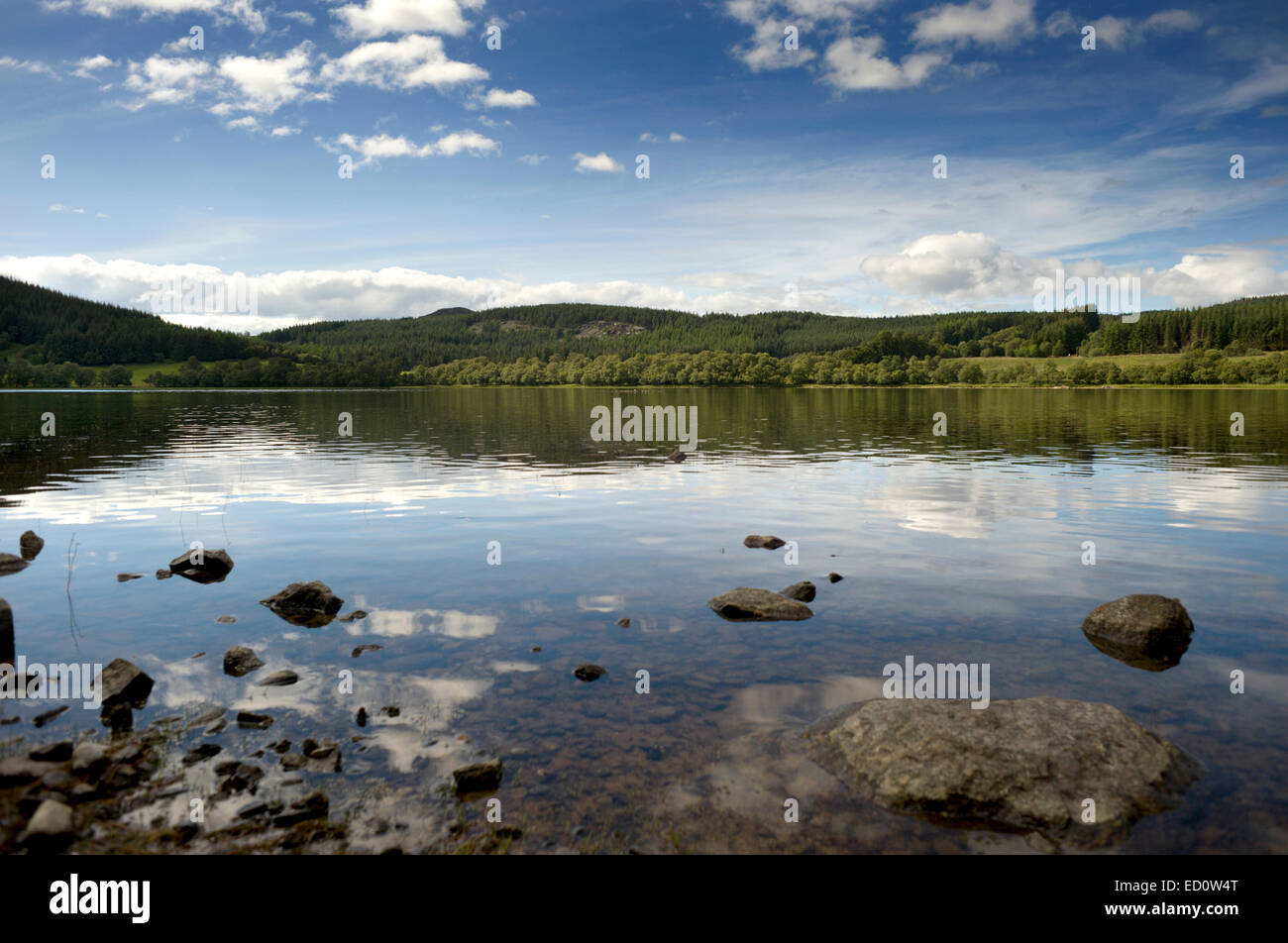 Summer sky reflected in the calm waters of the RSPBs Loch Ruthven in ...