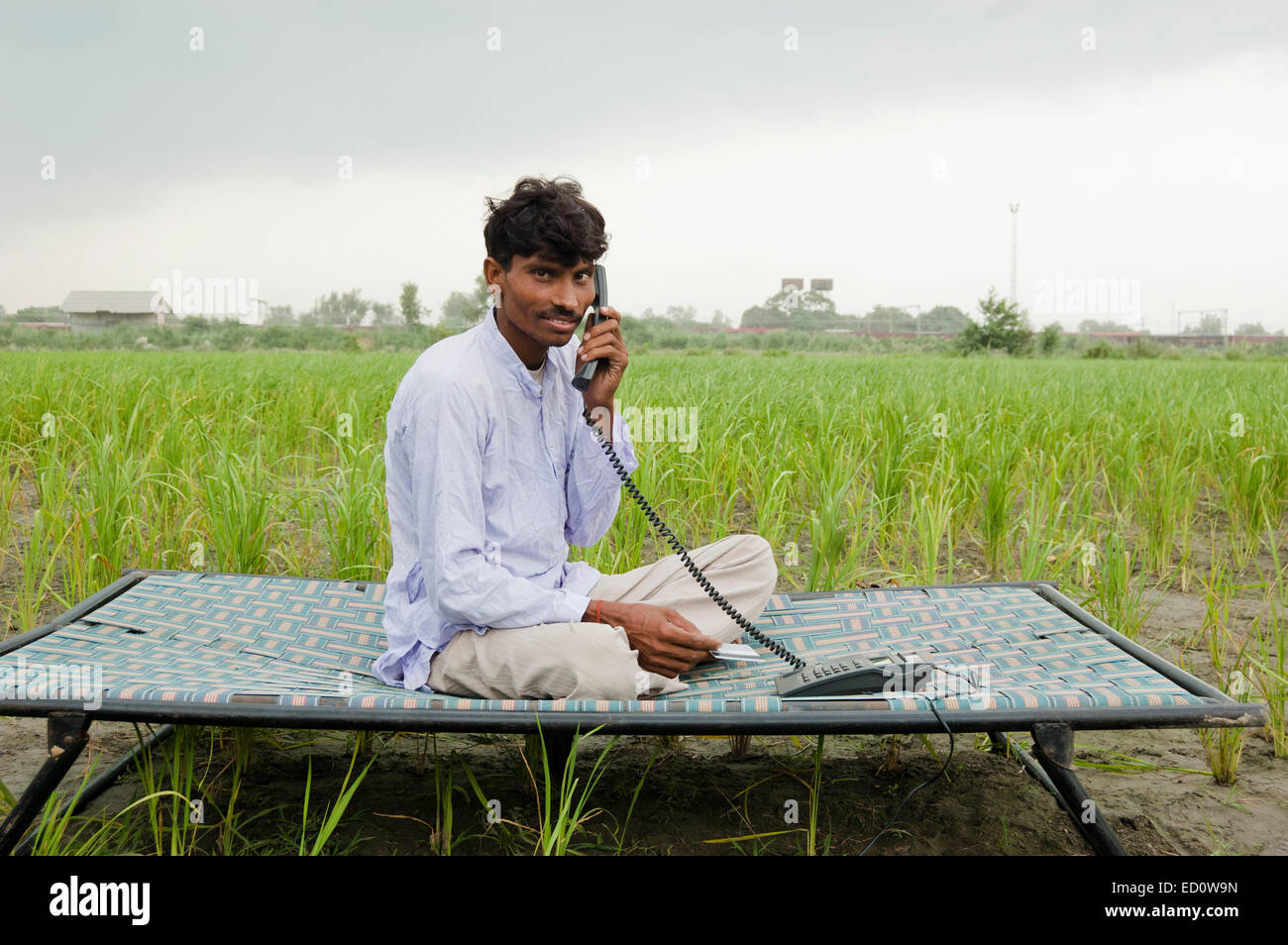 1 indian rural man field credit card with Talking Telephone Stock Photo ...