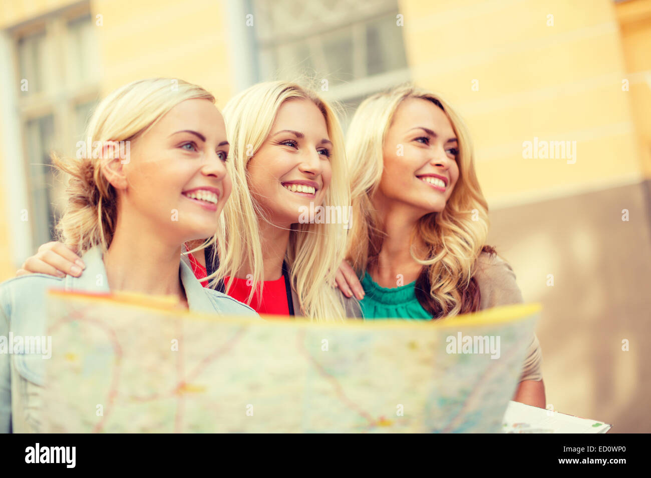 beautiful blonde women with map in the city Stock Photo - Alamy