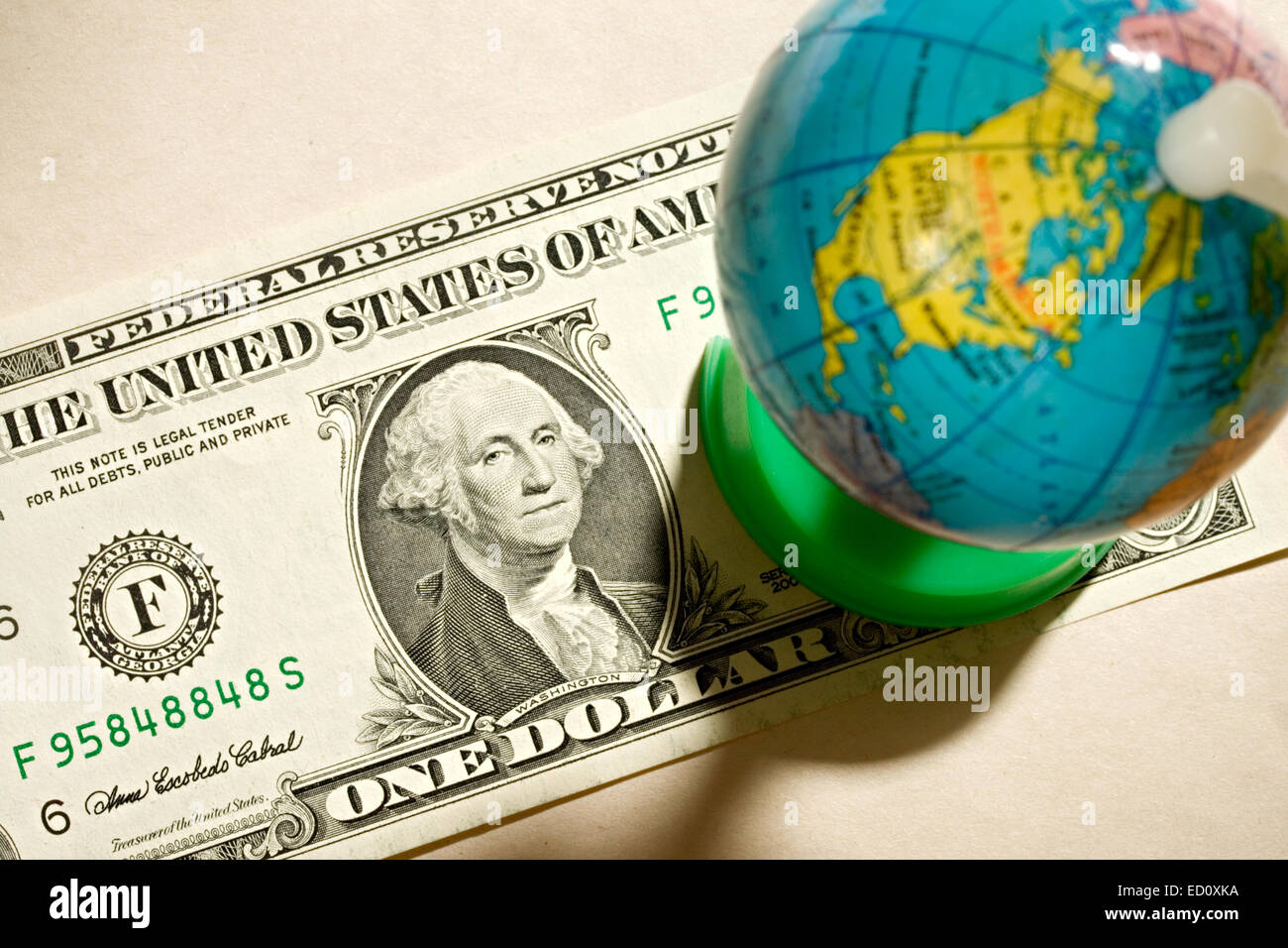 Globe and one dollar Stock Photo - Alamy