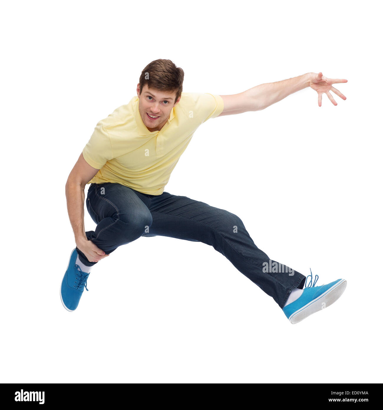 smiling young man jumping in air Stock Photo - Alamy
