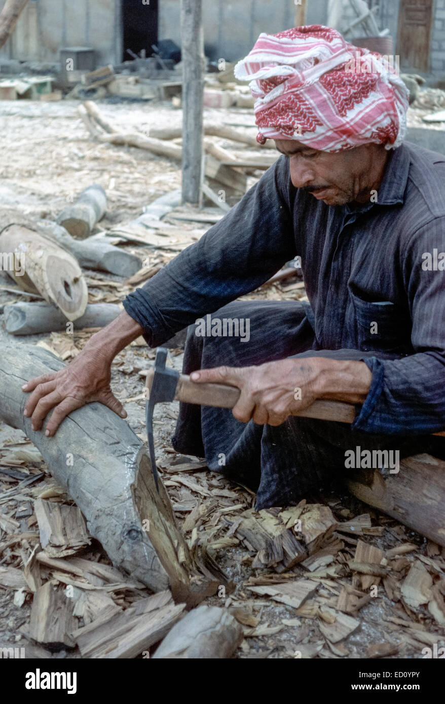 Kuwait April 1967. Carpenter Using an Adze to Shape a Log to Serve as ...