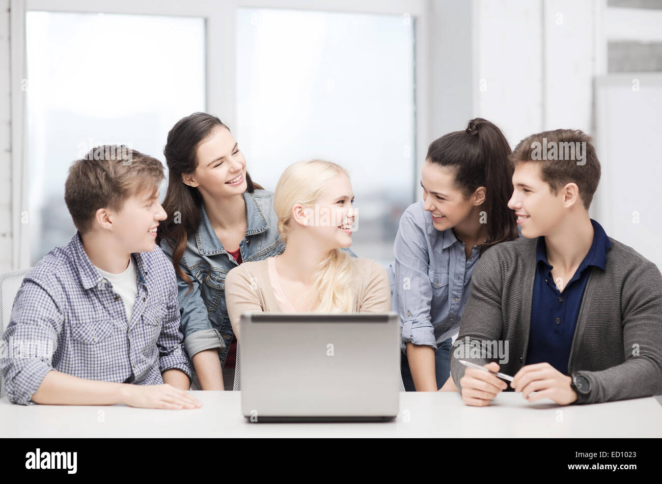 smiling students with laptop at school Stock Photo - Alamy