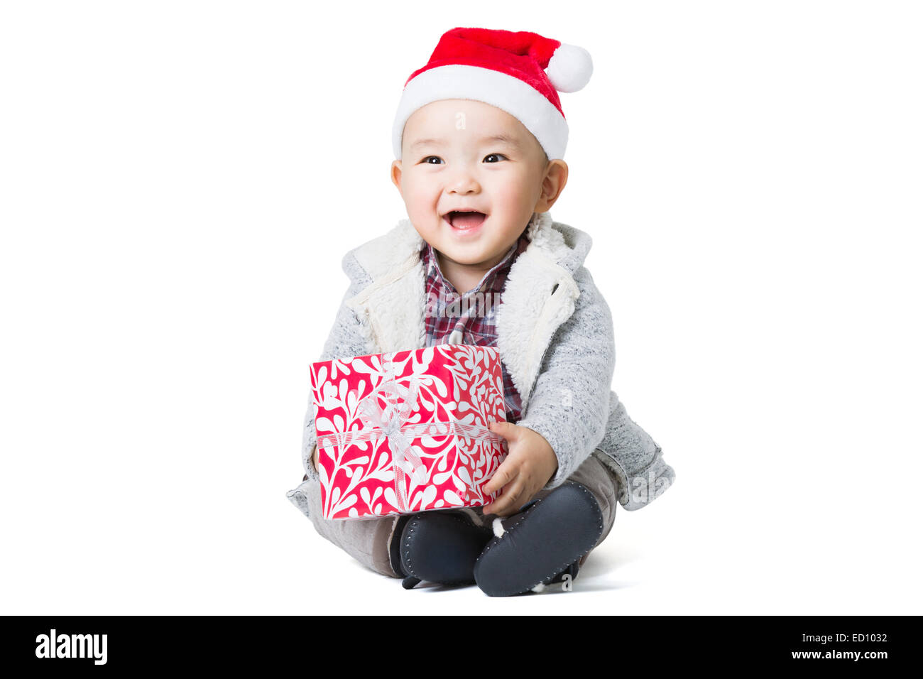 Cute baby with Christmas present Stock Photo - Alamy