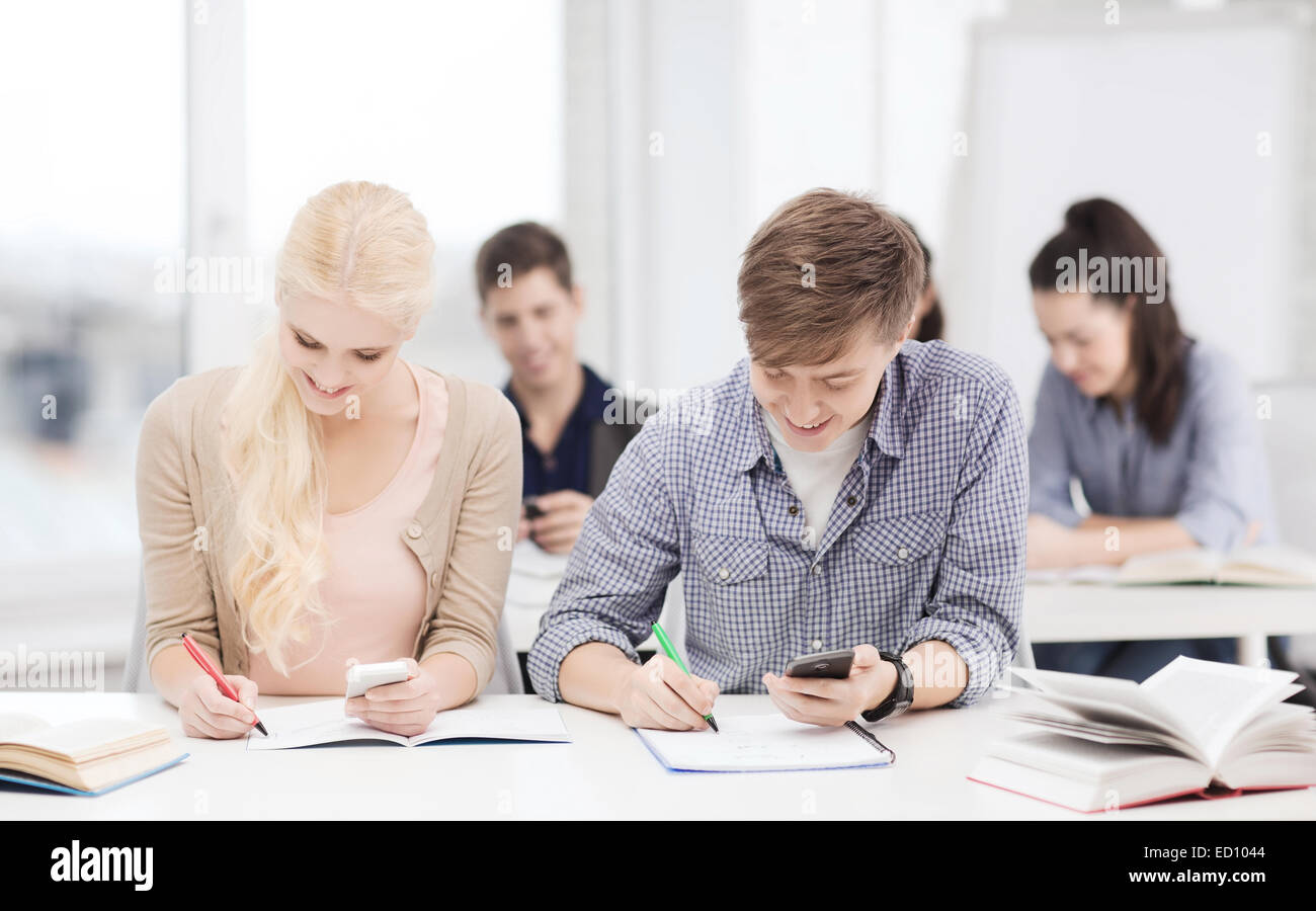 students looking into smartphone at school Stock Photo - Alamy