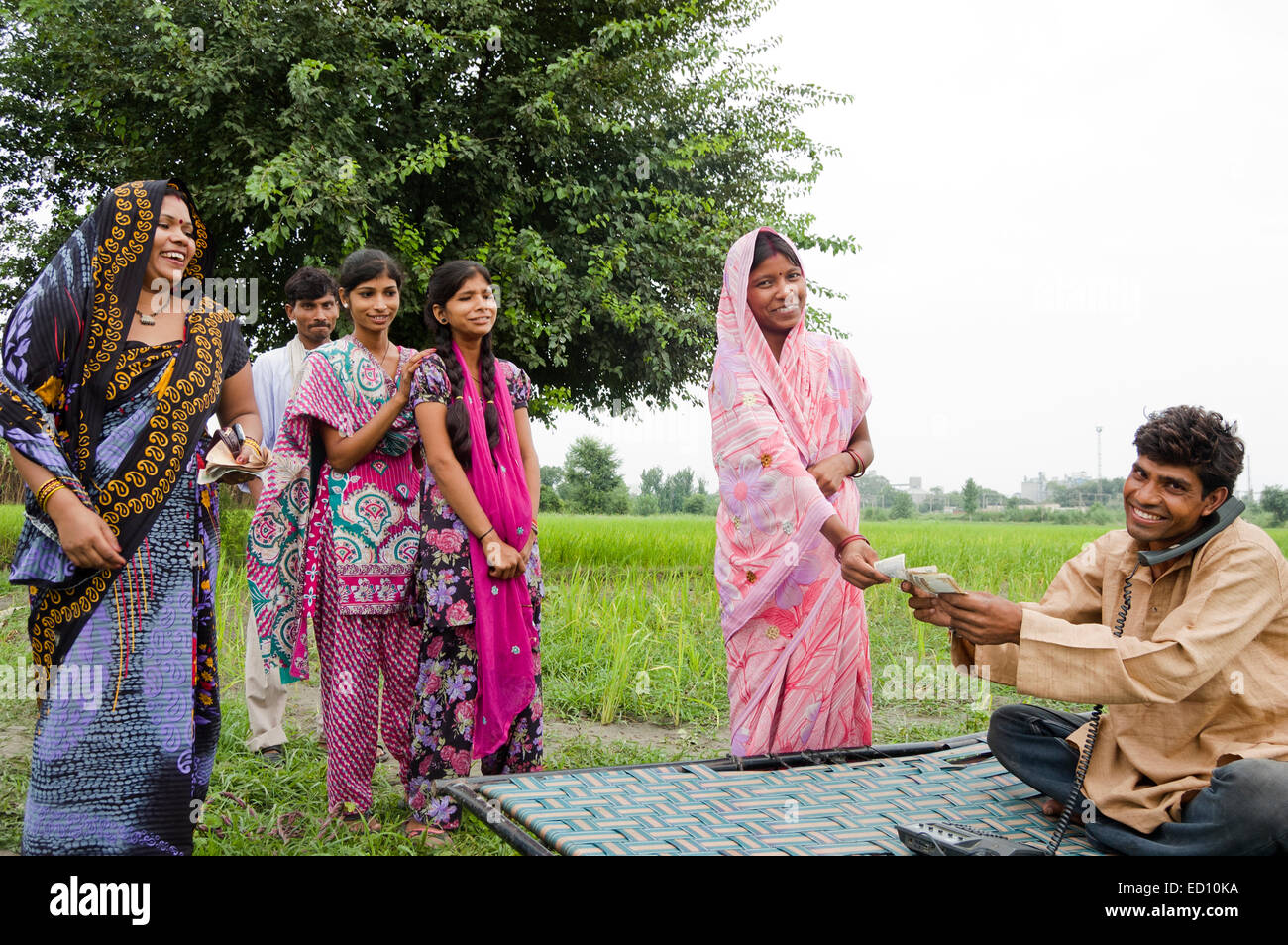1 indian rural farmer talking phone and Labor giving money Stock Photo ...