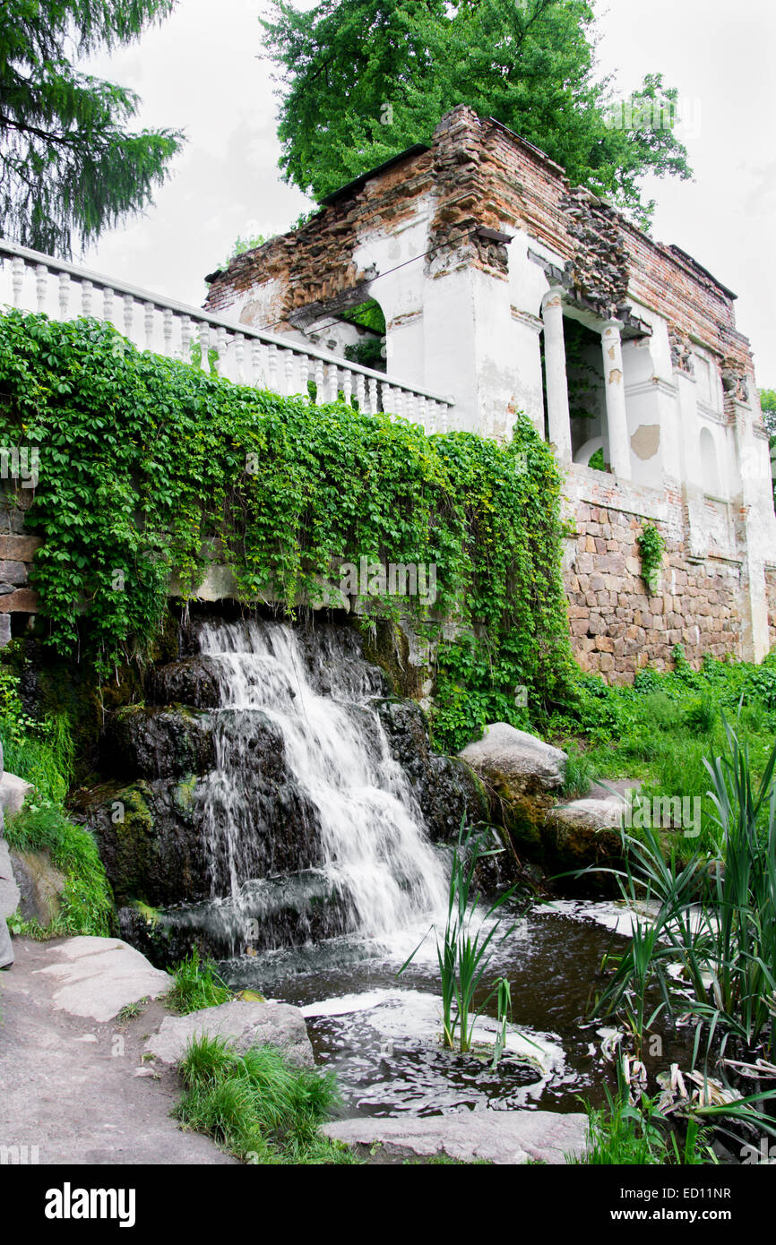 Ruins with waterfall in summer park Stock Photo - Alamy