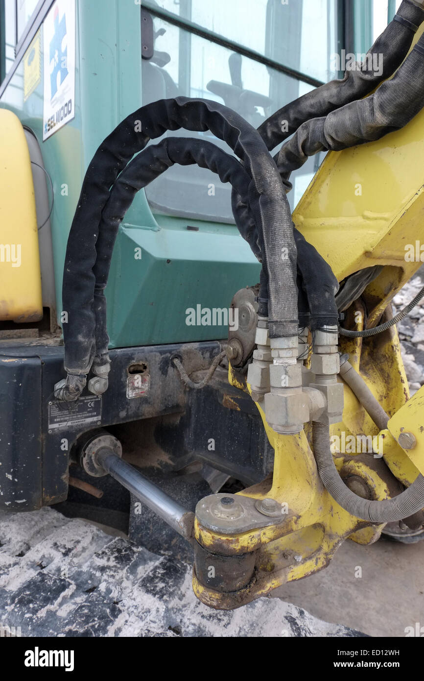 A small machine on the roof of a building being used for demolition on ...