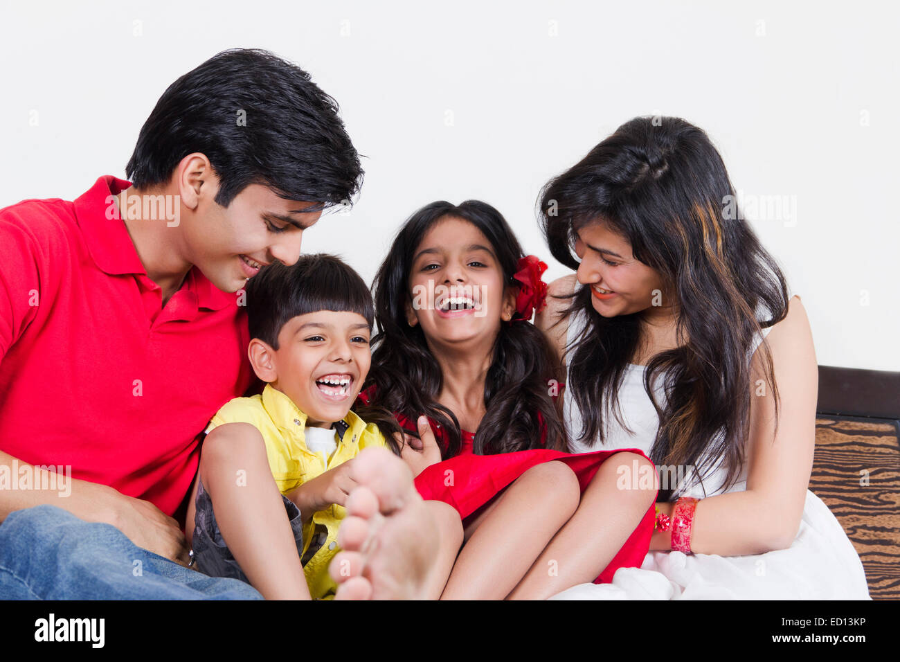 indian Parents with children home fun Stock Photo - Alamy