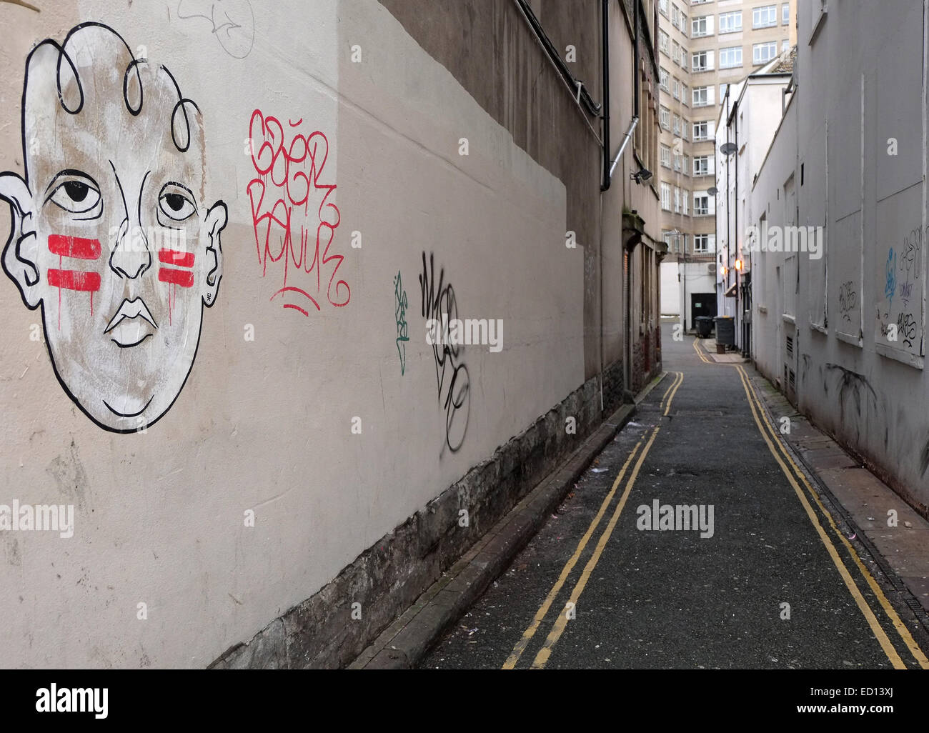 The very narrow Mark Lane in Bristol City centre, with face graffiti ...