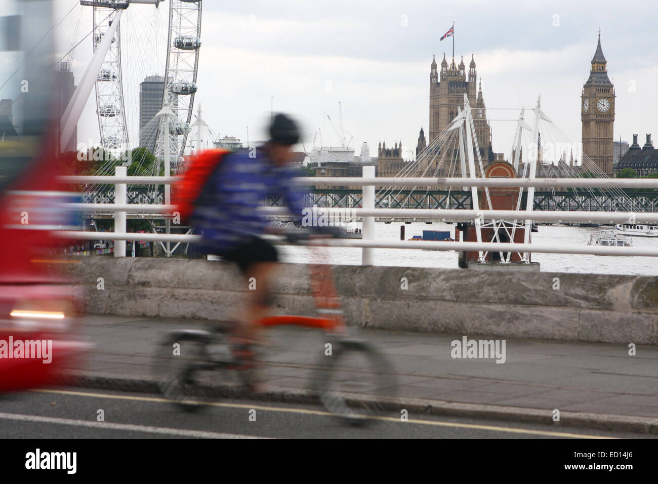 A cyclist and red London bus crossing Waterloo Bridge in London Stock ...