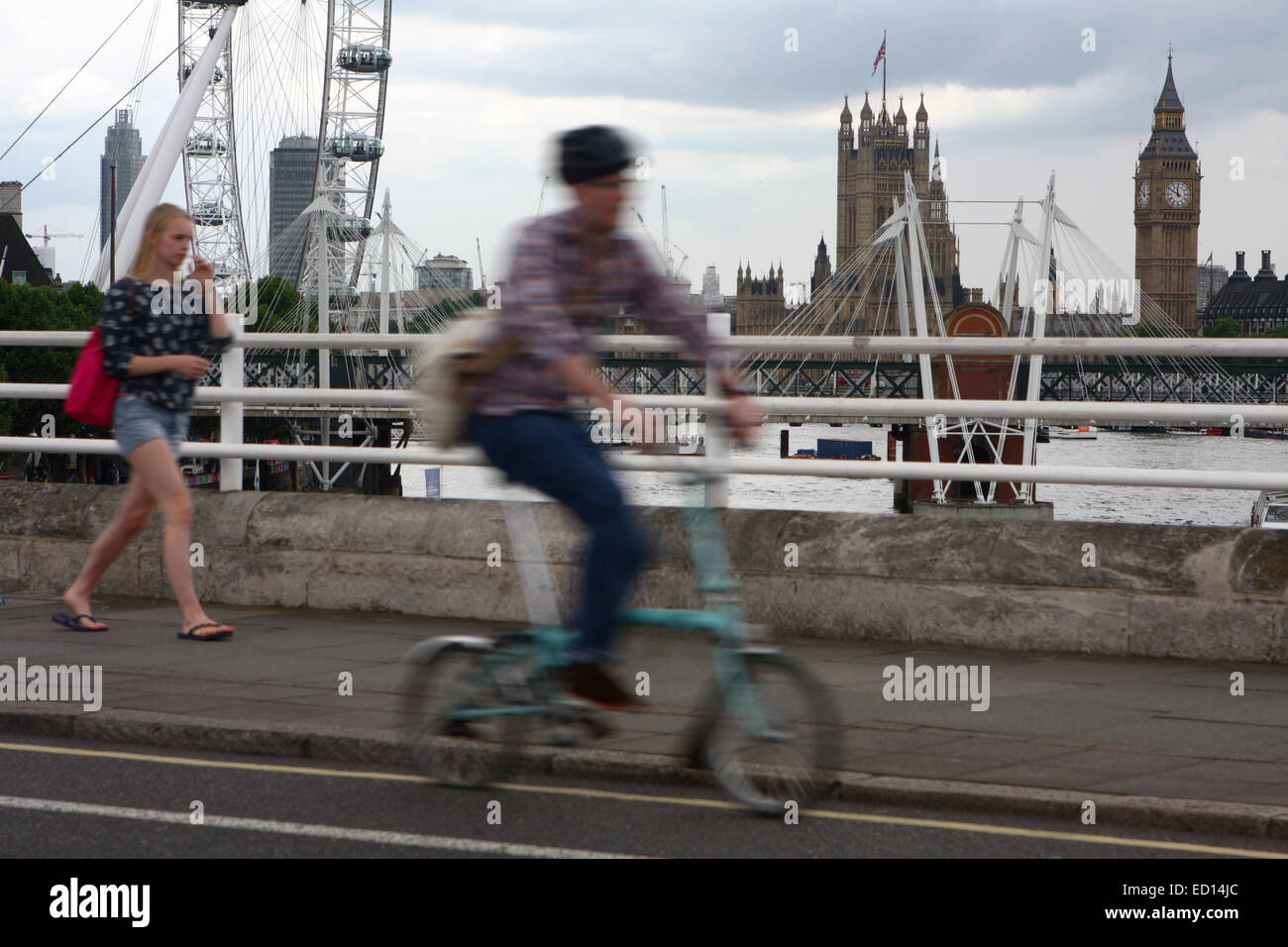 A cyclist and pedestrian crossing Waterloo Bridge in London Stock Photo ...