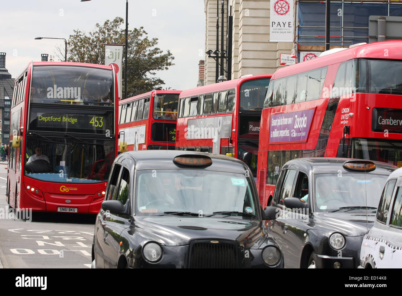 A queue of buses and taxis traveling along Oxford Street in London ...