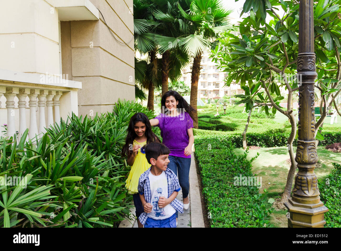 indian mother with children park running Stock Photo - Alamy