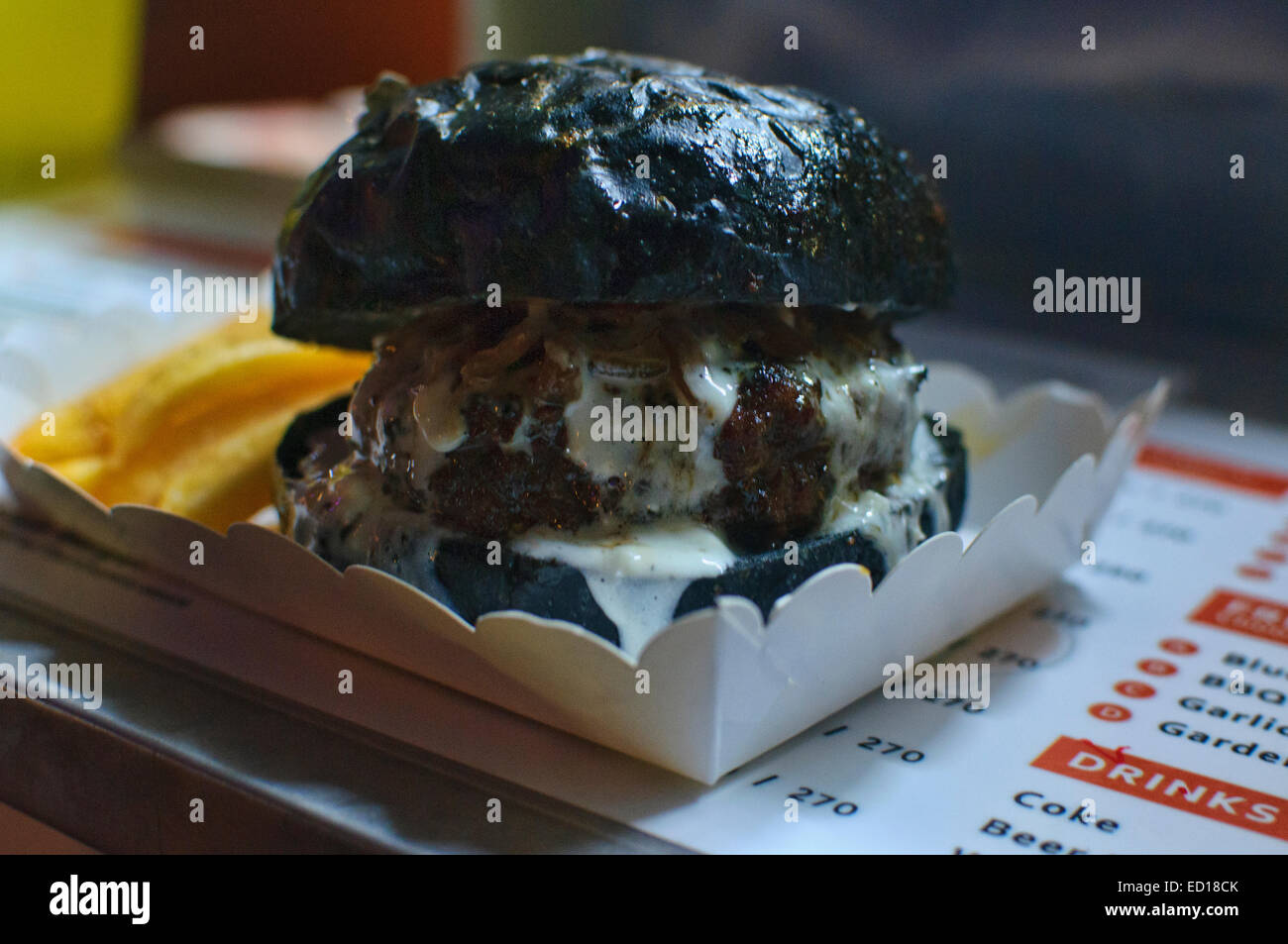 blue cheese burger on a black charcoal bun Stock Photo - Alamy