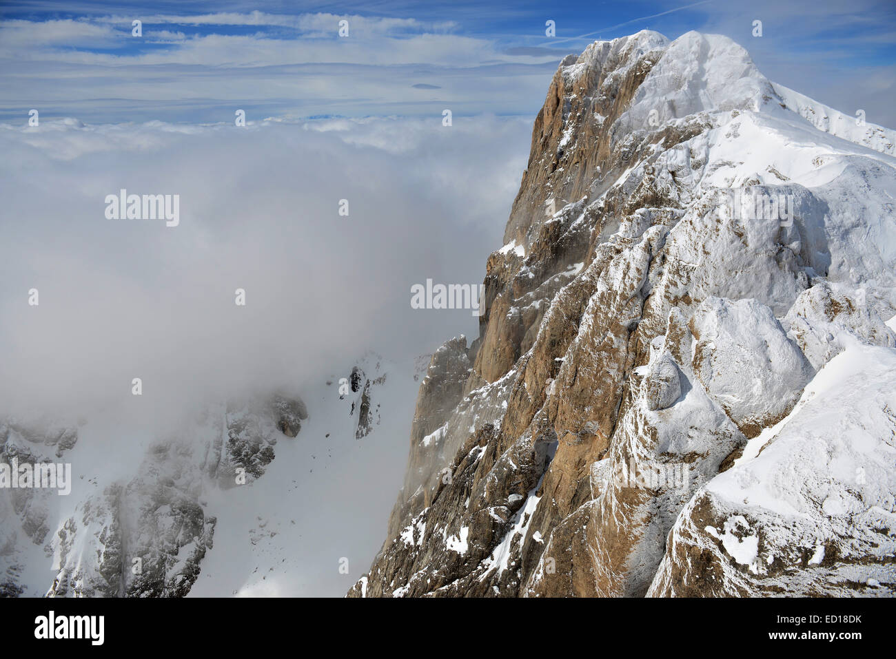 Horizontal landscape of snow and clouds covered mountain in the Alps ...