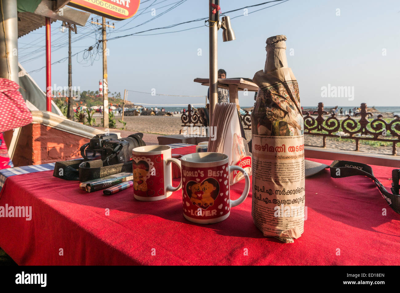Kerala, India - Kovalam. Lighthouse Beach. Beer in coffee mug to avoid ...