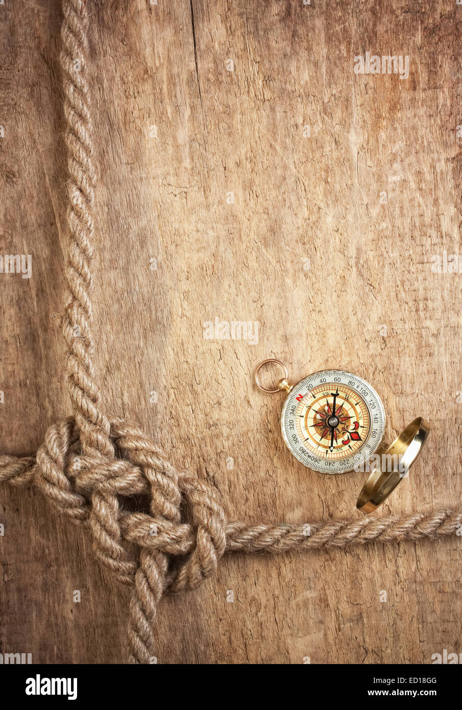 compass and rope knot on a wooden background Stock Photo - Alamy