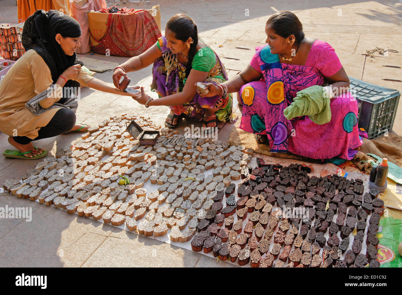 Women selling carved wood henna stamps in market, Ahmedabad, Gujarat ...