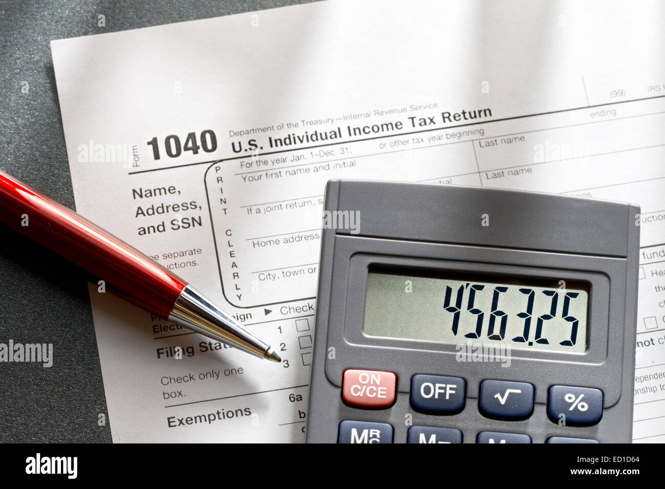 Tax form, red pen and calculator Stock Photo - Alamy