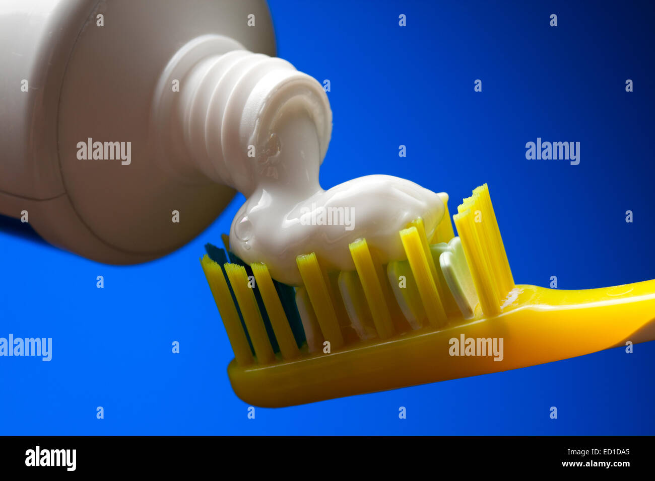 Toothbrush and toothpaste on a blue background Stock Photo - Alamy