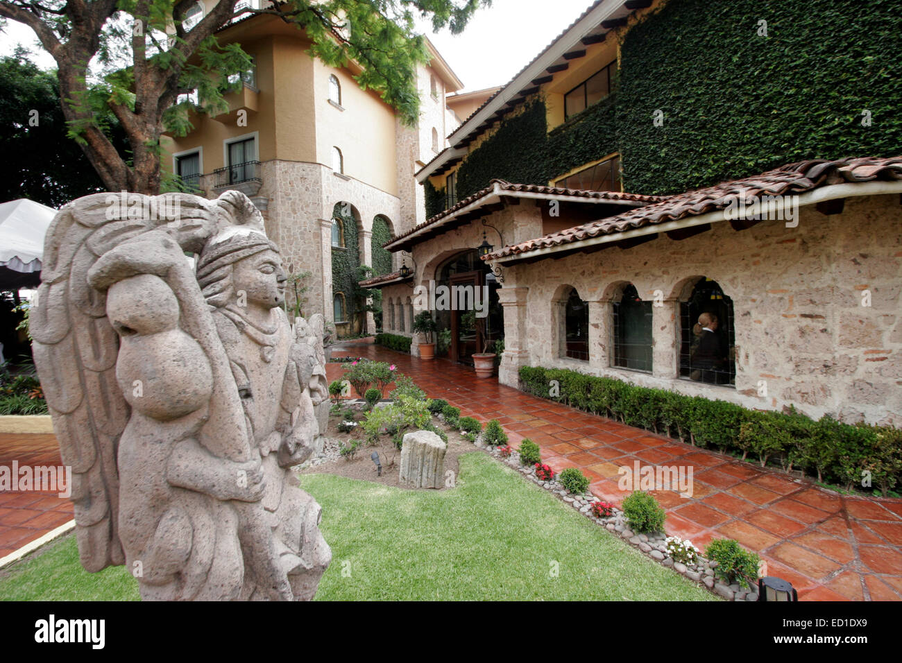 Colonial style stone walls and arches embrace guests at the luxurious ...